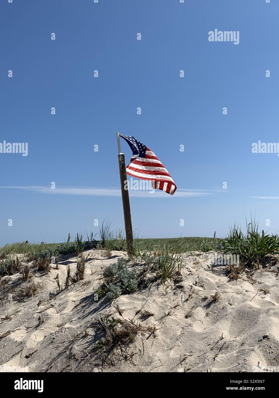 A flag on a sand dune in Chatham,MA Stock Photo - Alamy