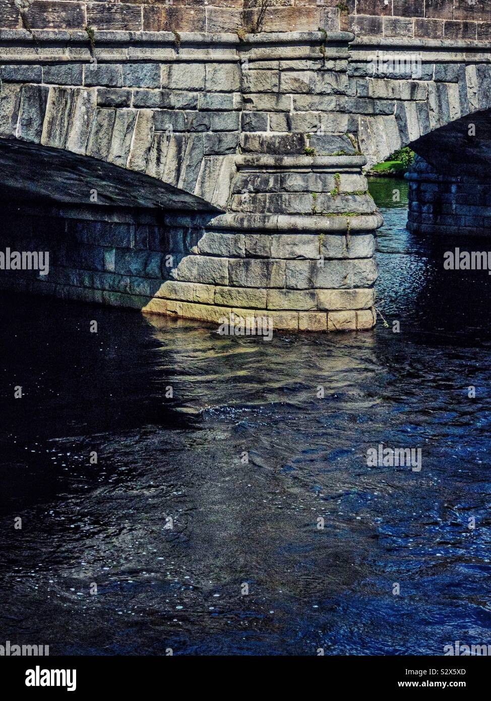 Detail of old stone bridge over a river Stock Photo - Alamy