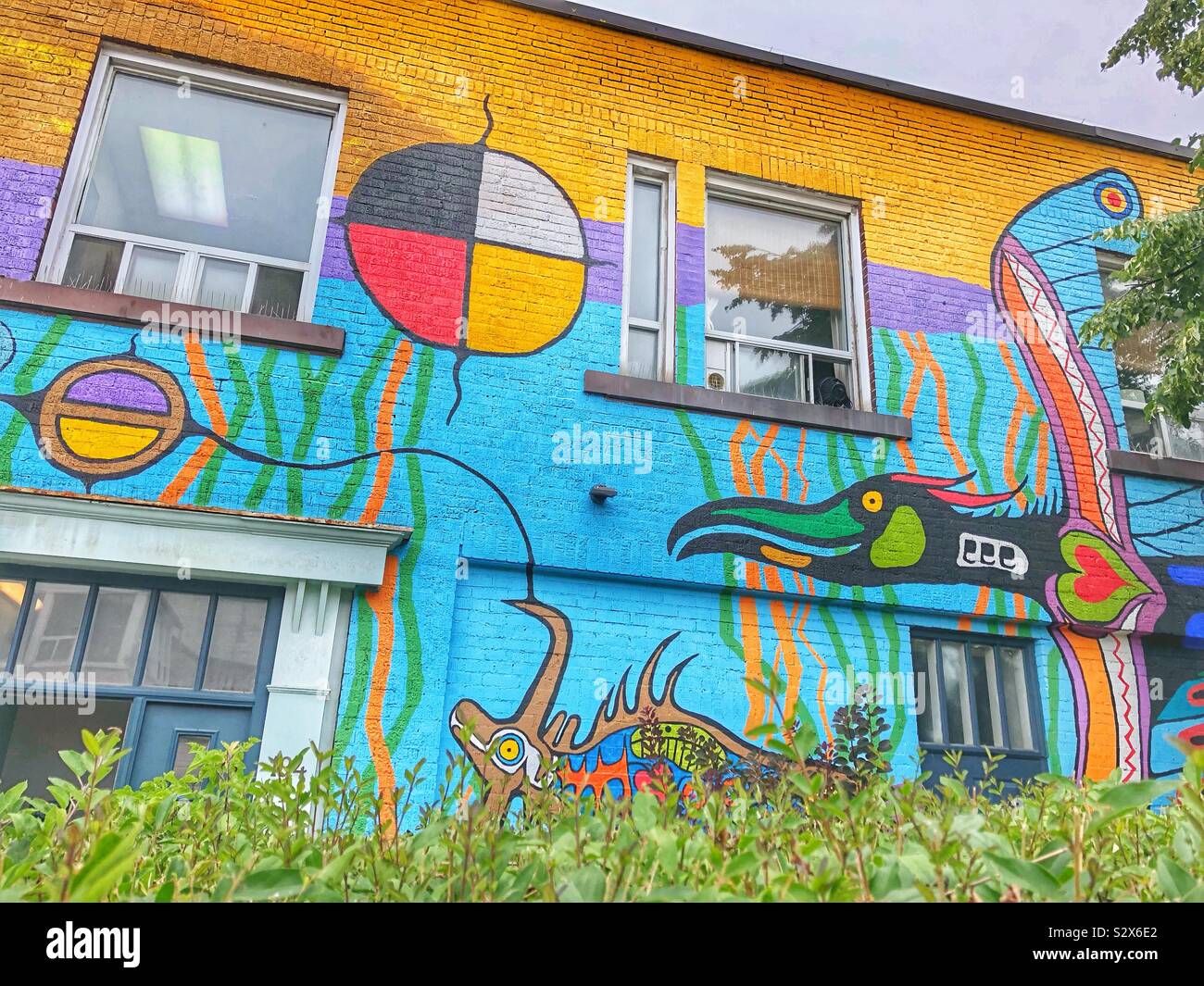 An indigenous themed mural on a building exterior wall in a Toronto ...