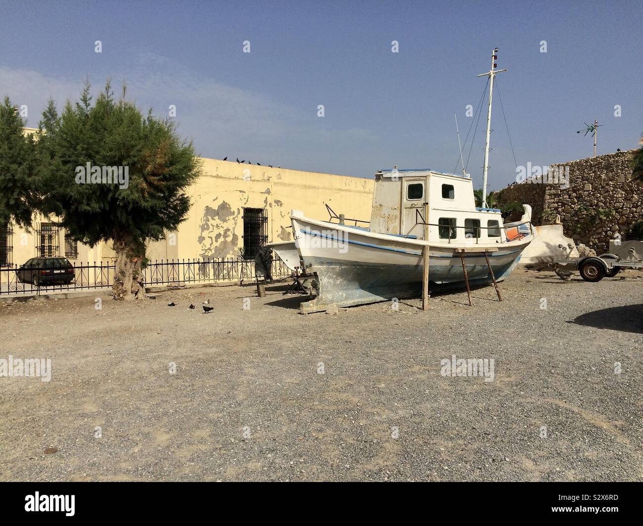 Old fishing boat with blue sky in background in ancient harbor of ...