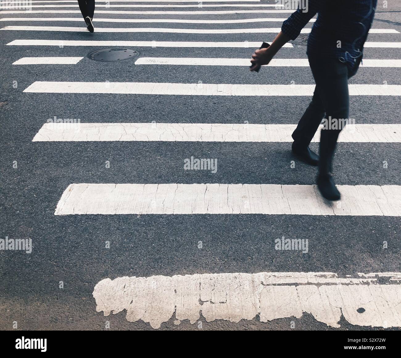People cross a street on a lined crosswalk in New York City Stock Photo ...