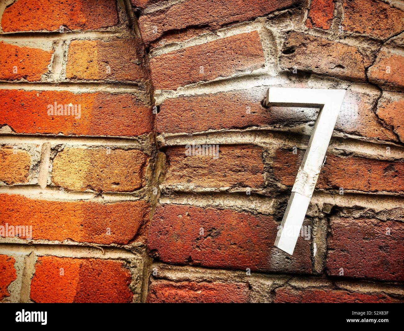 A number seven in a brick wall in a home in Coyoacan, Mexico Stock ...