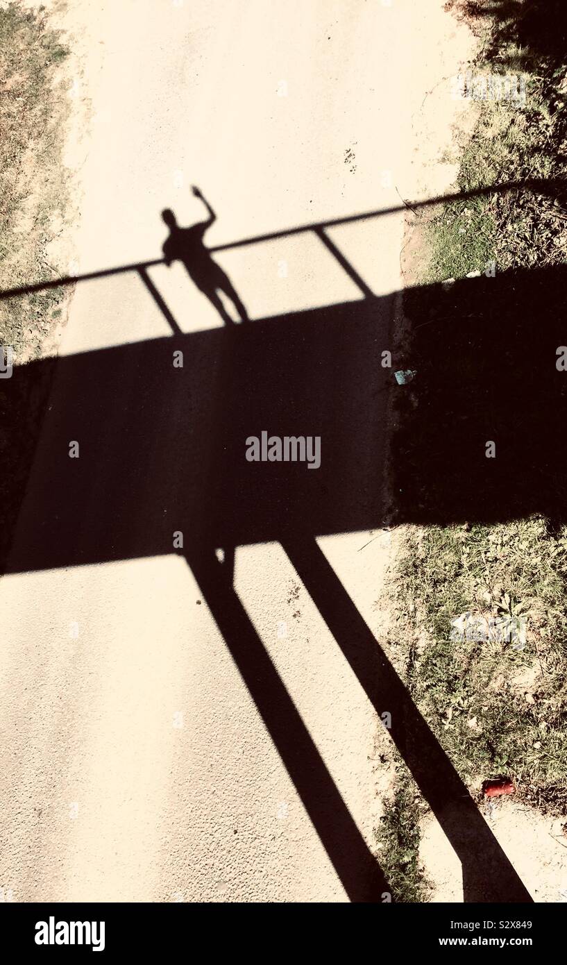 Mans shadow on a bridge Stock Photo - Alamy