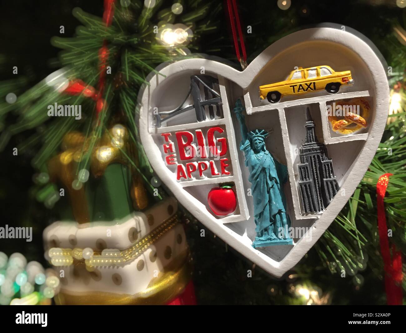 Ornament depicting New York City landmarks and icons hanging on a ...