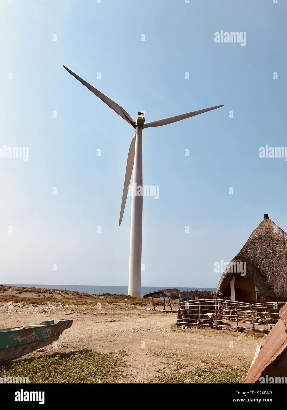 A tall wind turbine on a beach at Burgos, Ilocos Norte, Philippines ...