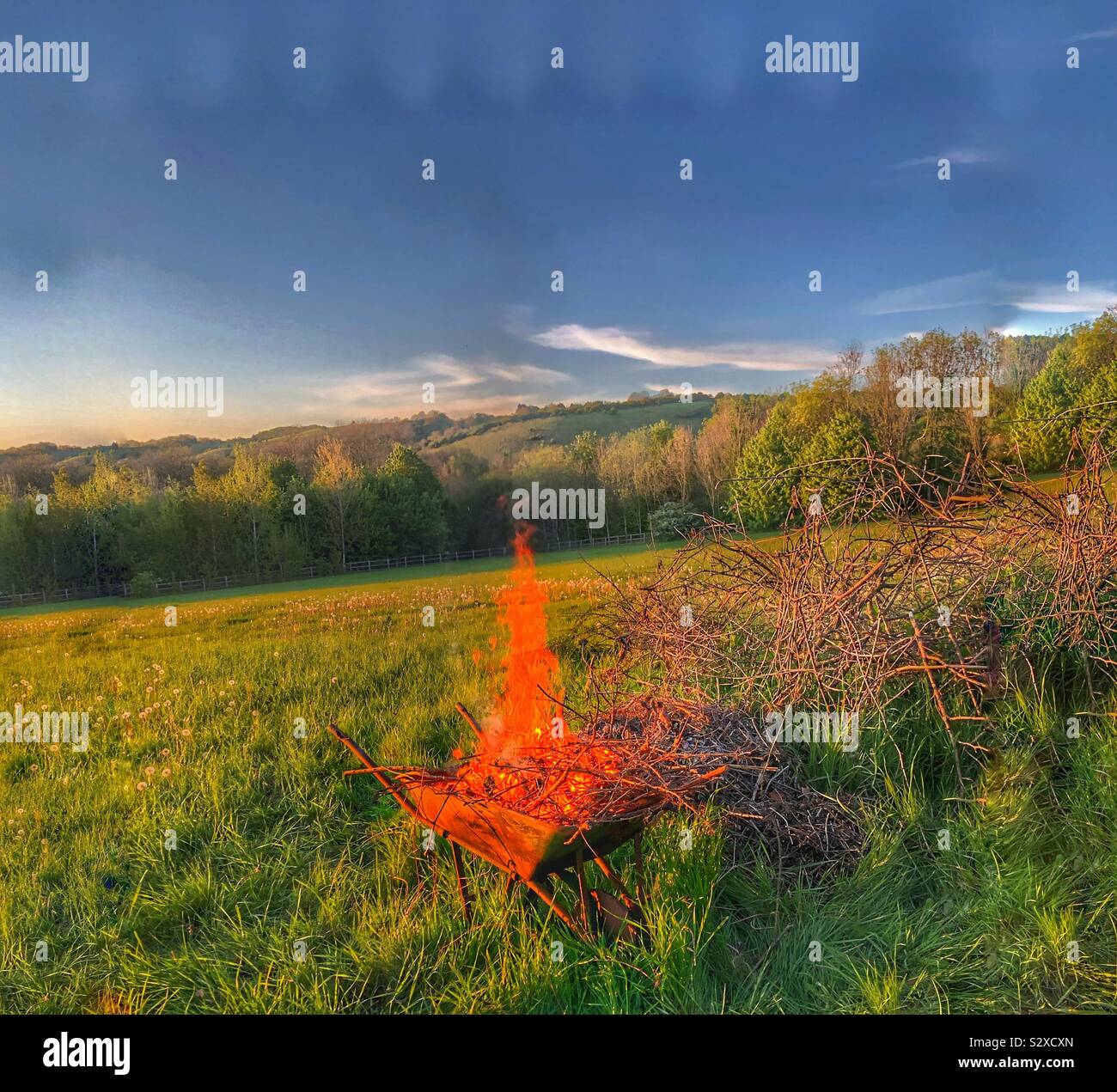 Wheelbarrow fire with rolling hills view Stock Photo - Alamy