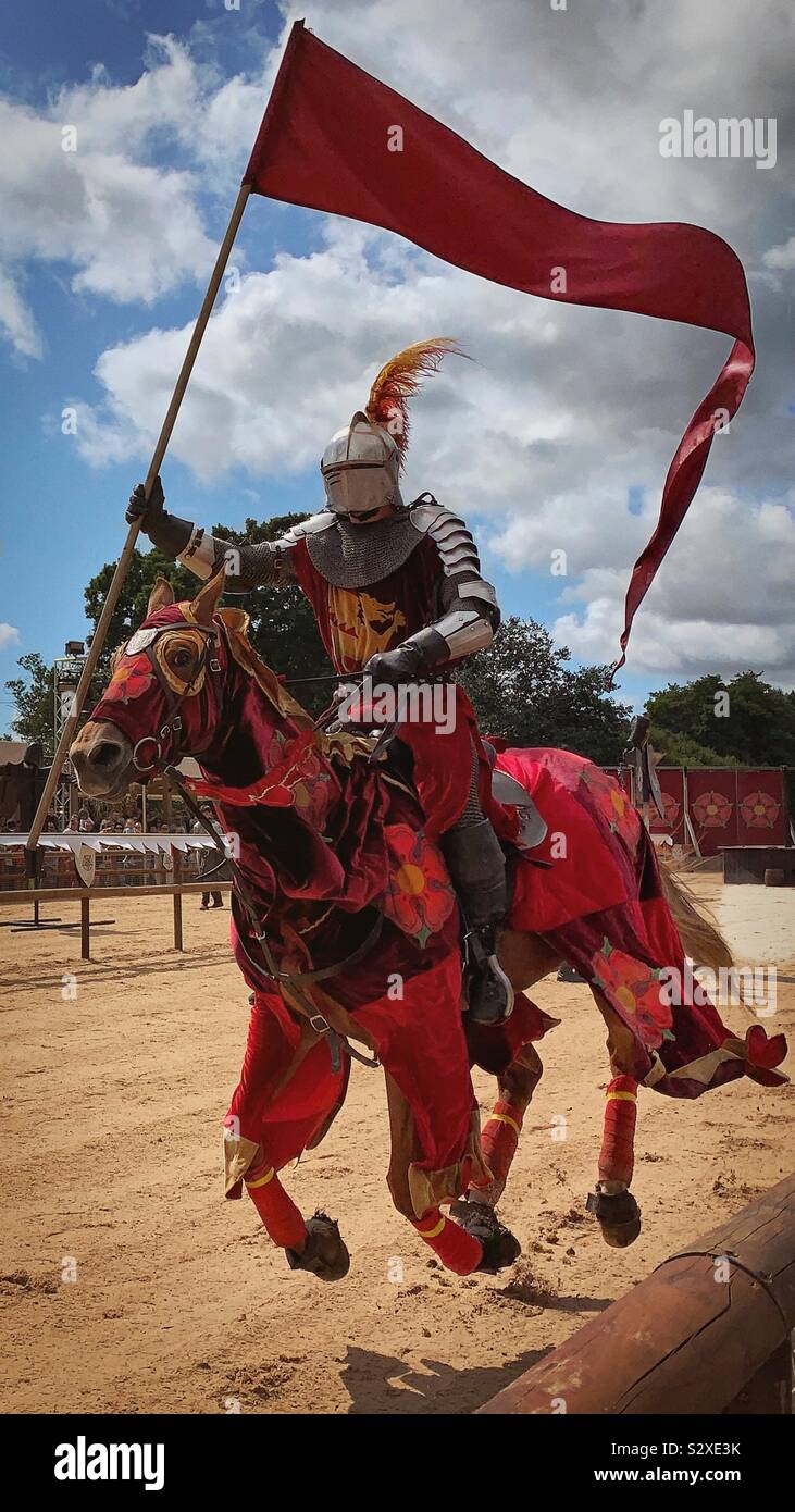 Red knight on a horse as part of the War of the Roses show at Warwick ...