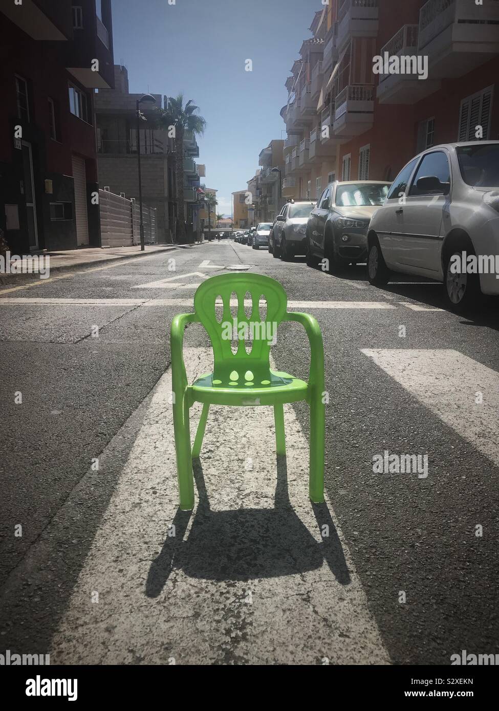 Green childs chair on a pedestrian crossing on street in Tenerife ...