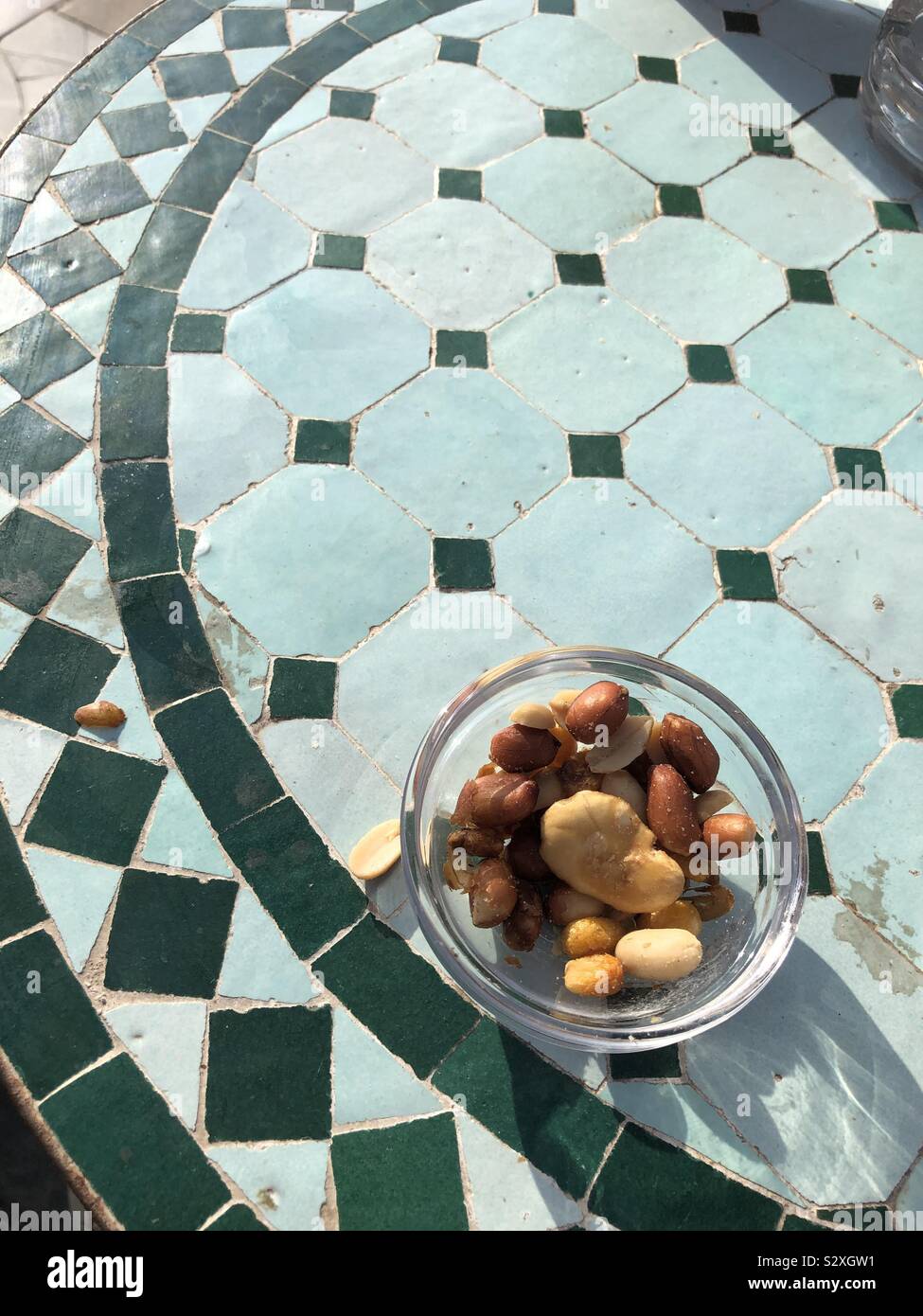 Rustic tiled table with a bowl of mixed nuts Stock Photo - Alamy