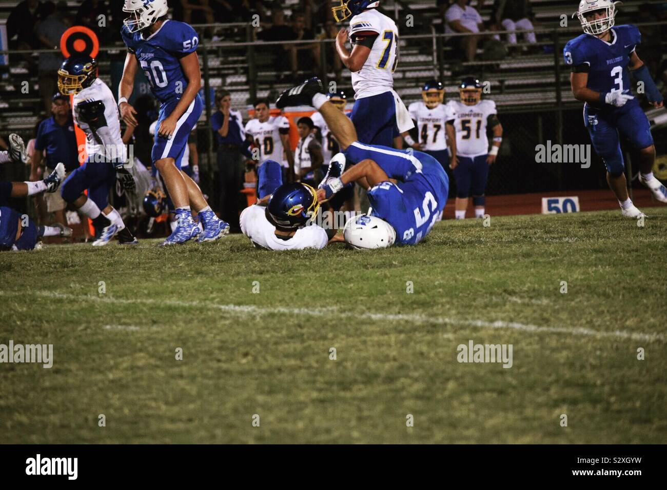 Football player mid tackle Stock Photo - Alamy