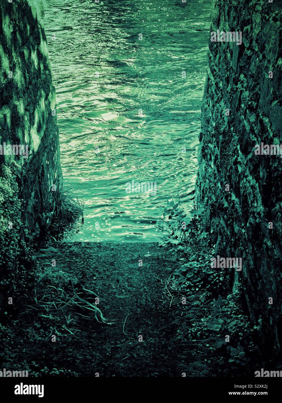 Path leading into river Stock Photo - Alamy