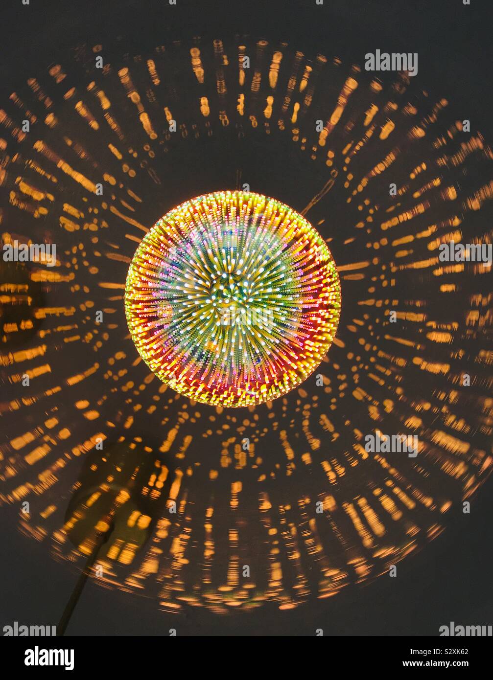 Multi coloured light bulb giving a strange light effect Stock Photo - Alamy