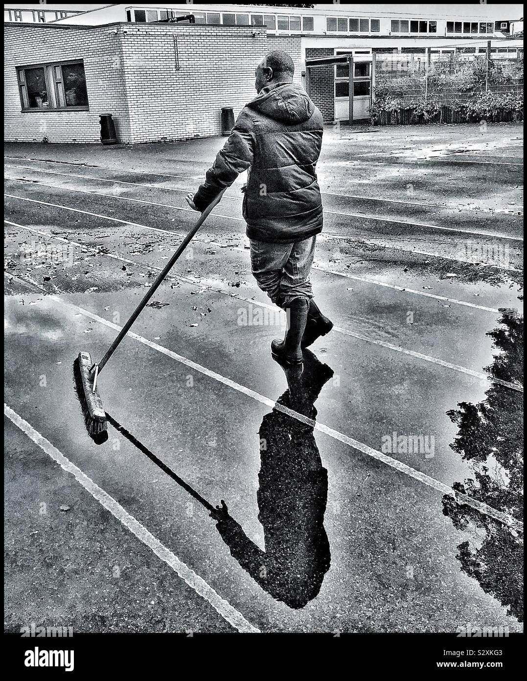 Sweeping up after a rain shower Stock Photo - Alamy