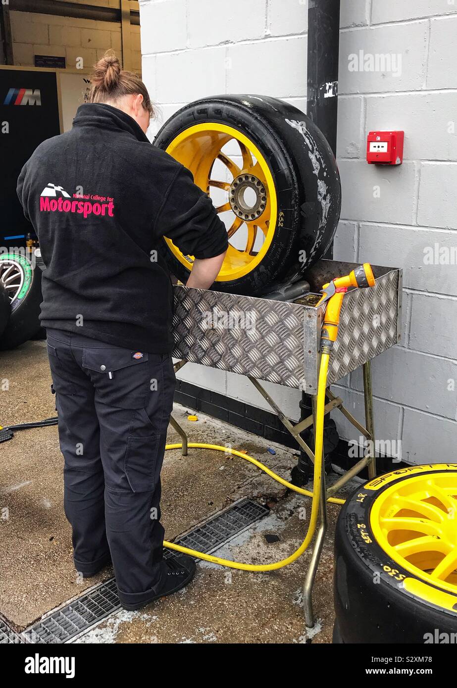 Woman Washing Wheels At The BTCC- Silverstone UK 2019 Stock Photo - Alamy