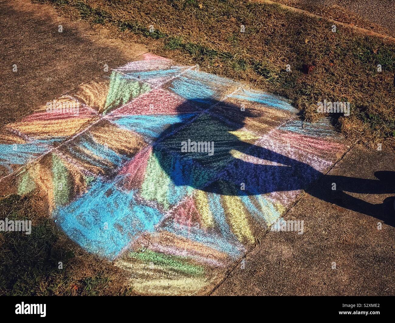 Child’s shadow against block of chalk drawing on sidewalk Stock Photo ...