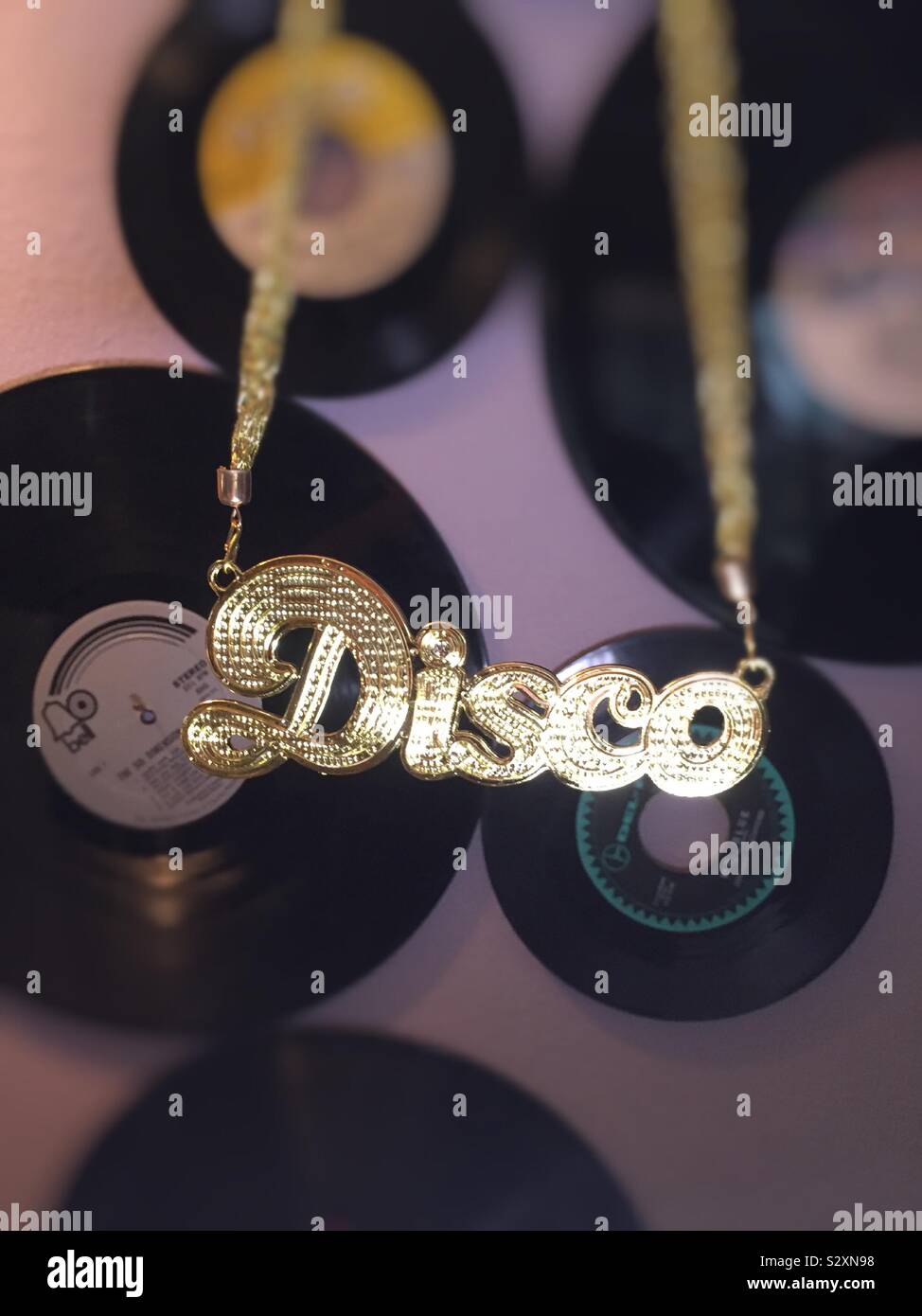 Close up of a gold disco chain in front of vinyl records, USA Stock ...