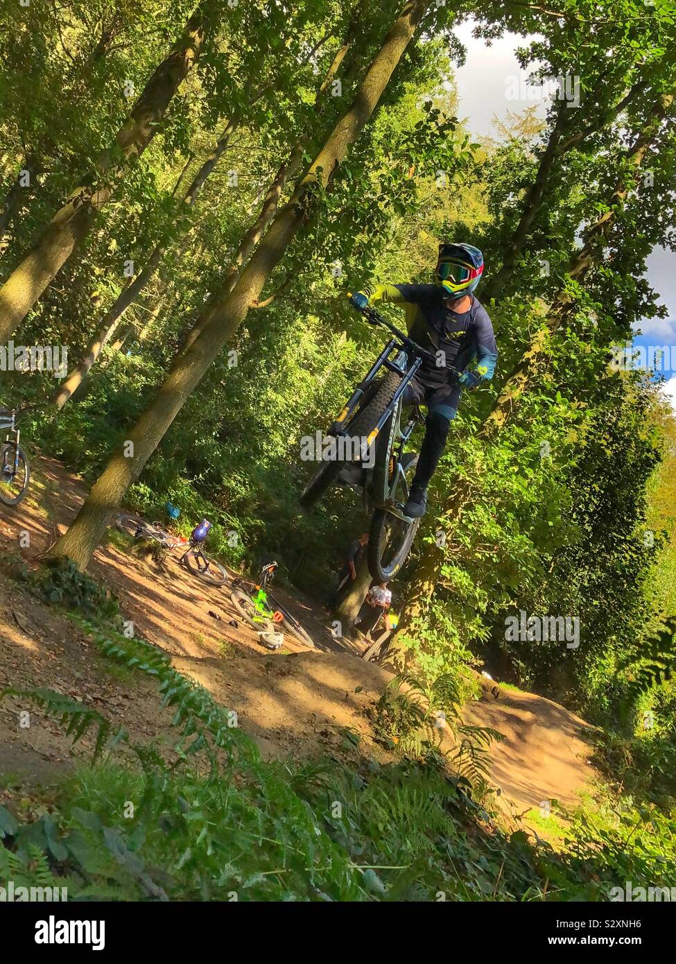 Downhill Mountain Biker jumping in Esholt Woods Stock Photo - Alamy