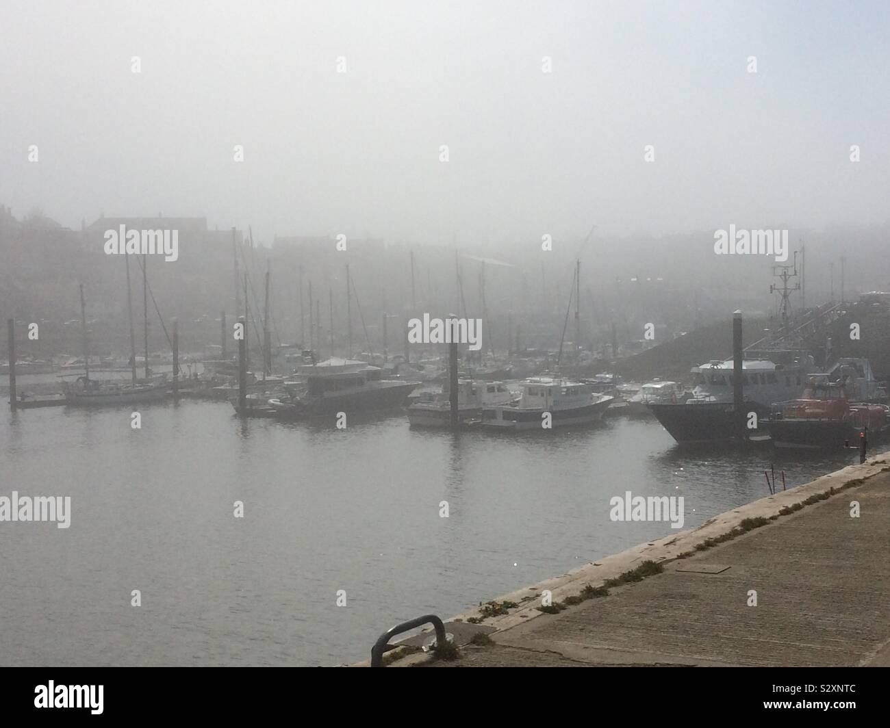 Whitby harbour in the mist Stock Photo - Alamy