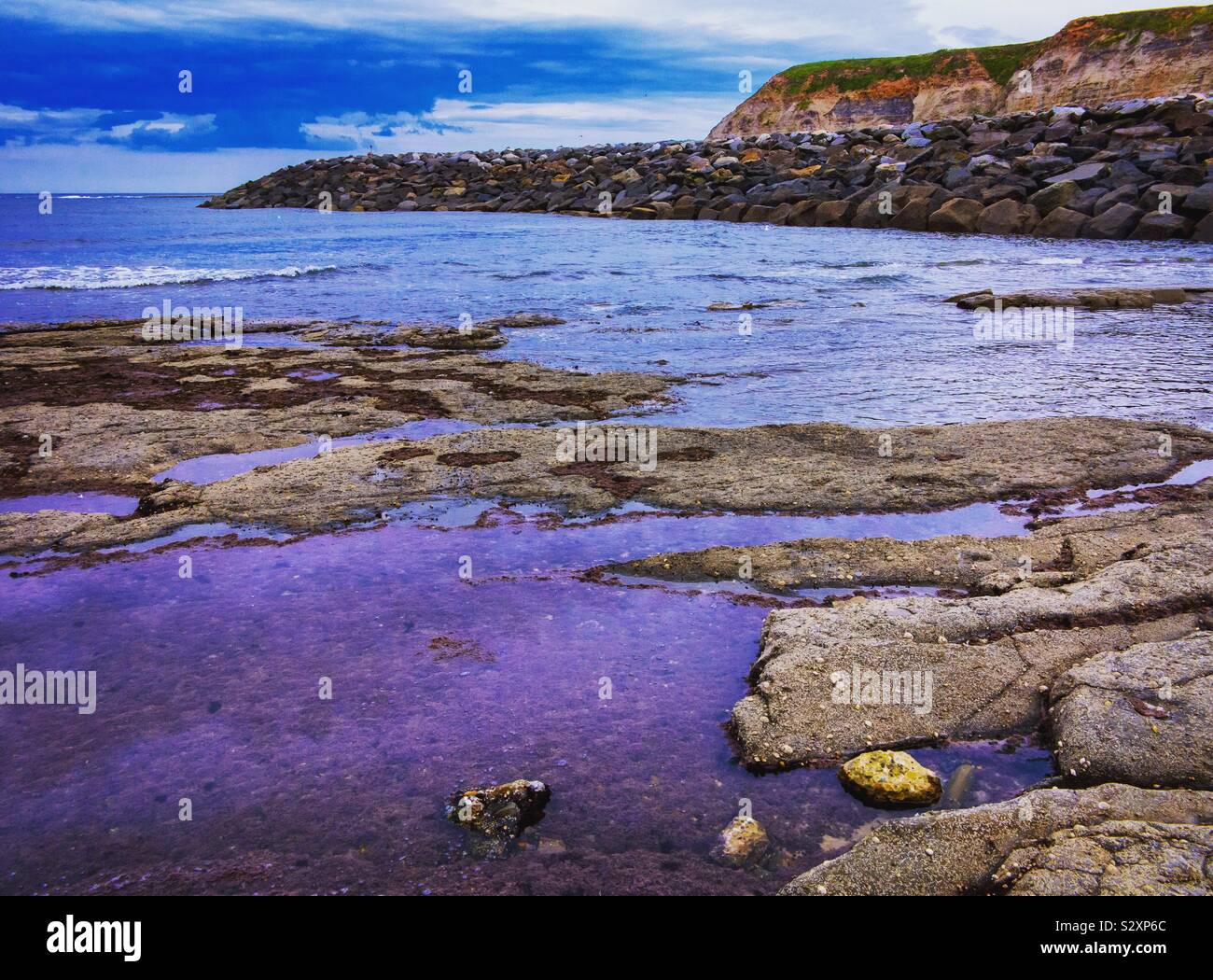 Wave cut platform on the beach at Staithes in North Yorkshire England ...