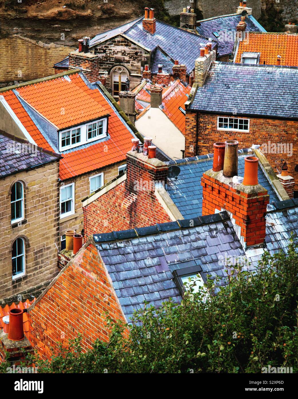 View over rooftops of houses in the village of Staithes in North ...