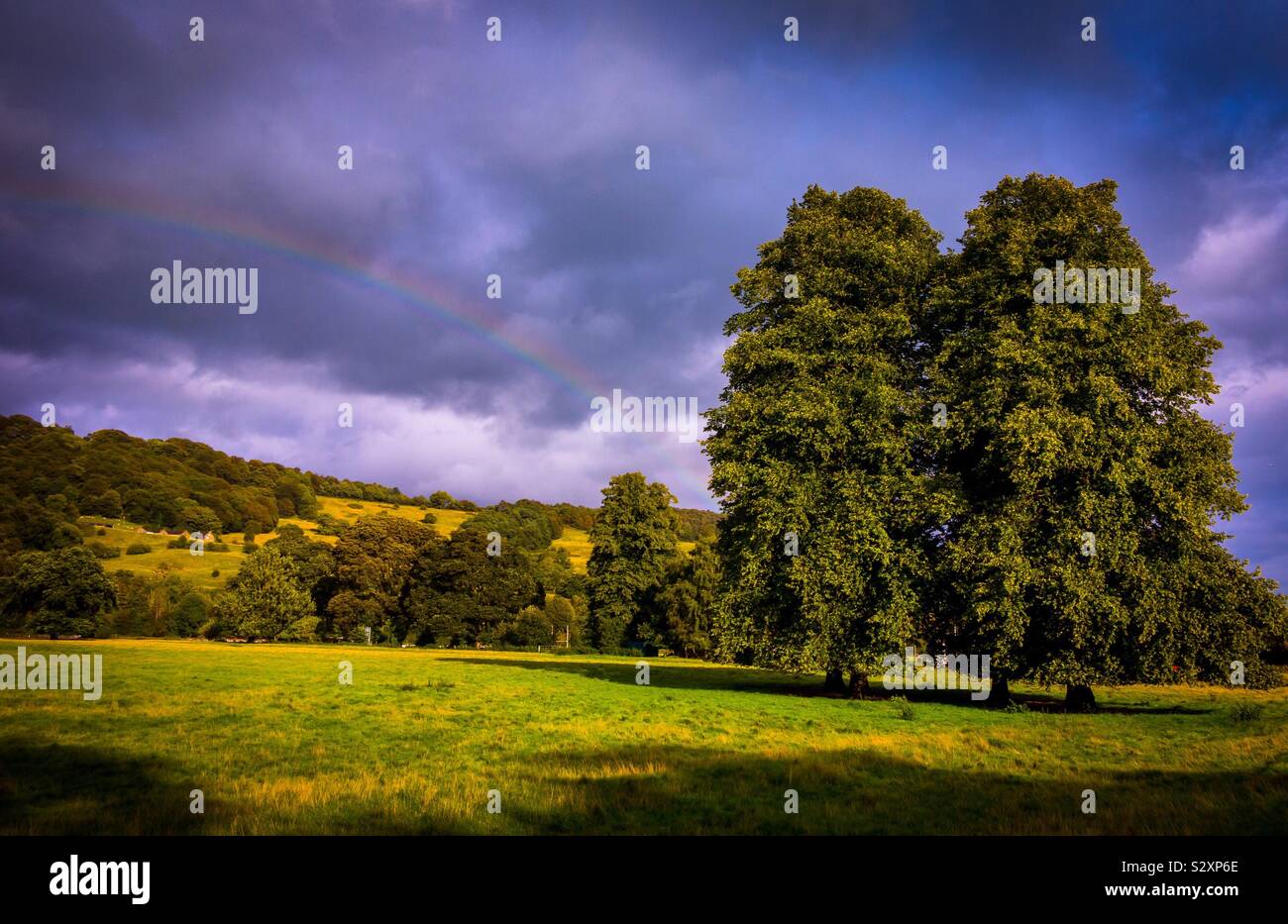 Rainbow over countryside in Cromford Derbyshire Peak District England ...