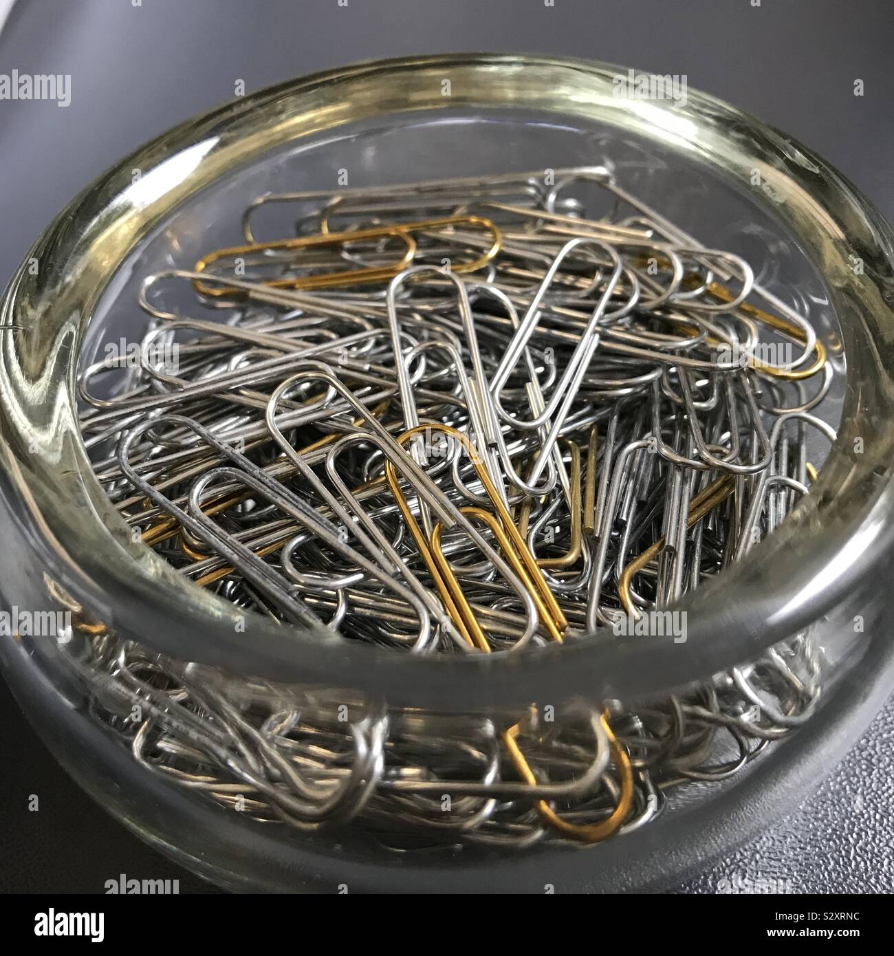 Paper clips in a glass pot Stock Photo - Alamy