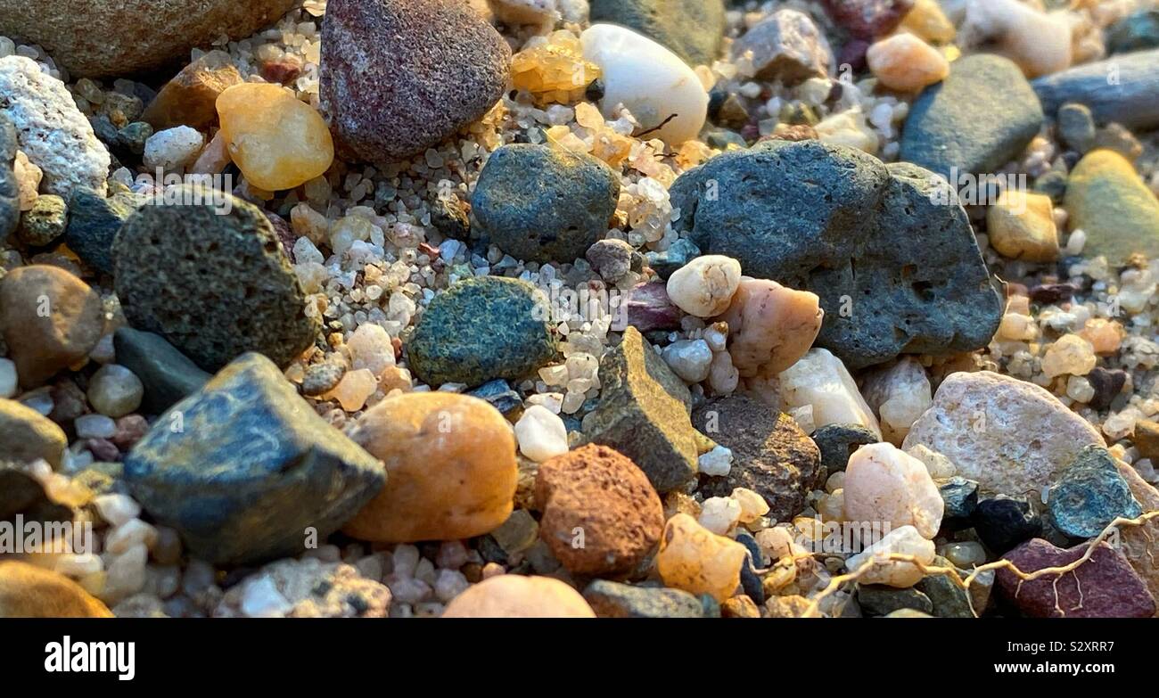Pebbles on sand Stock Photo - Alamy