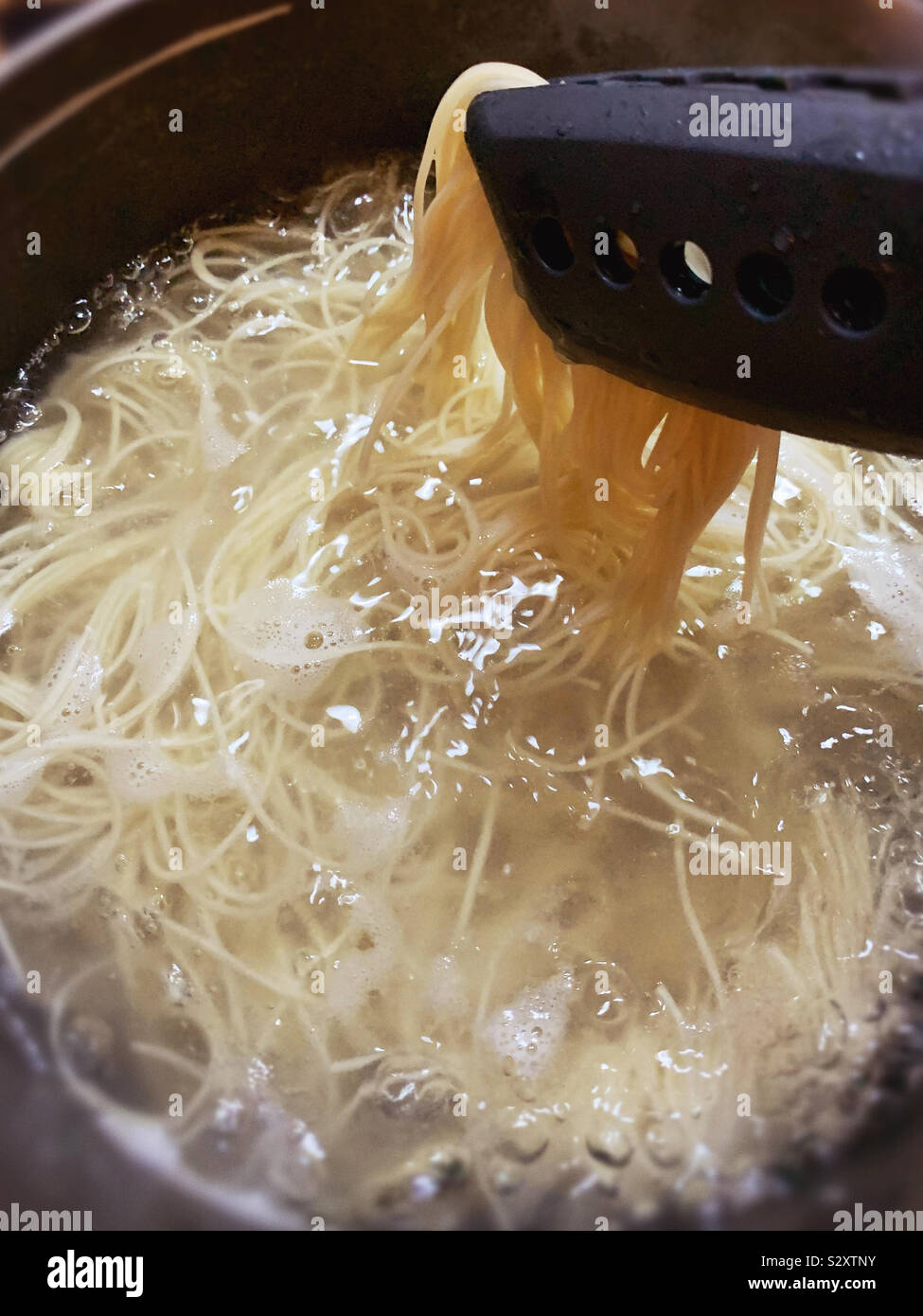 Noodles or pasta in boiling water Stock Photo - Alamy