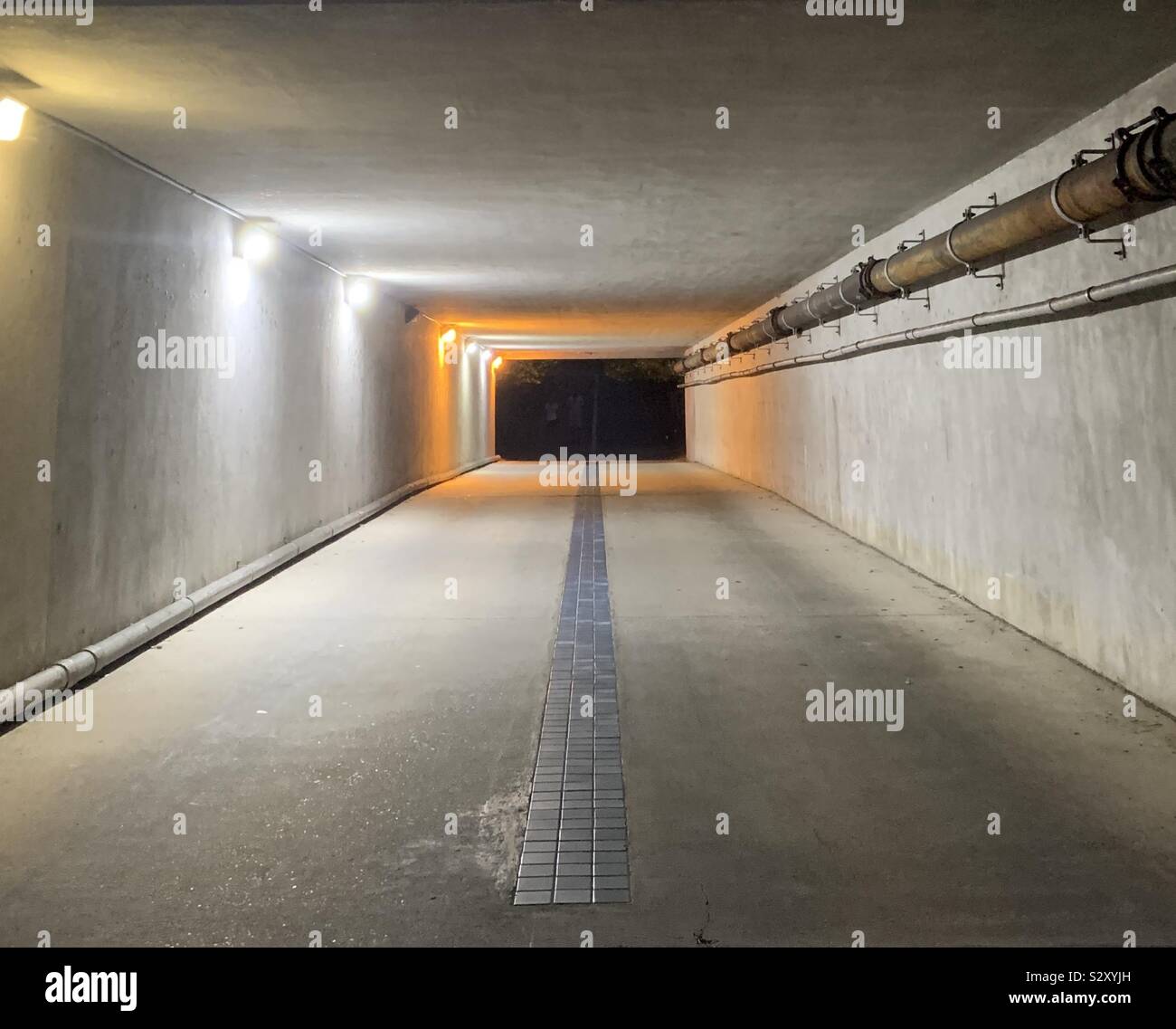 Inside of a tunnel lit up at nighttime Stock Photo - Alamy