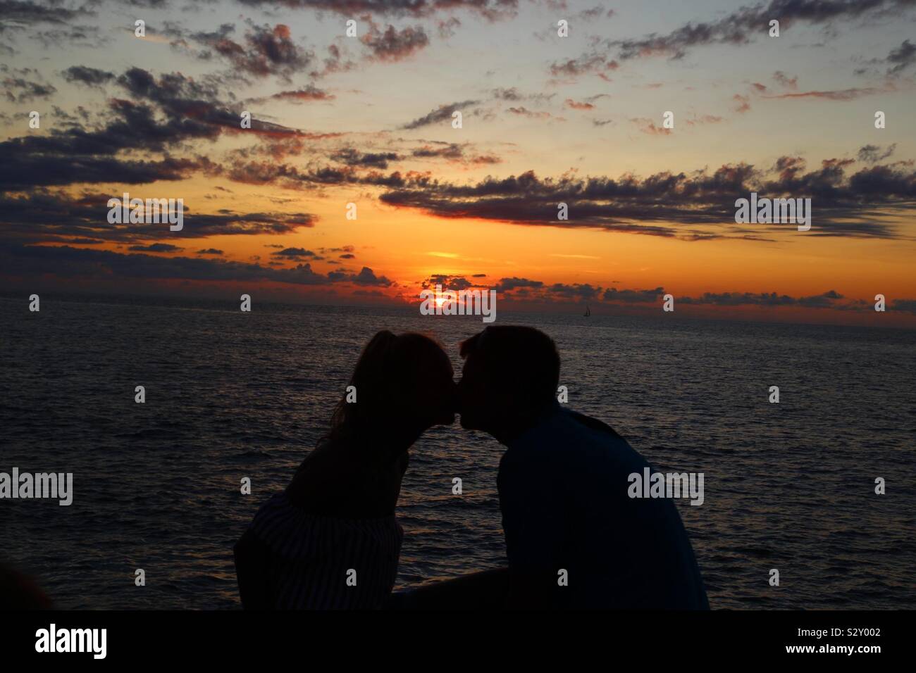 Kissing at sunset Stock Photo - Alamy
