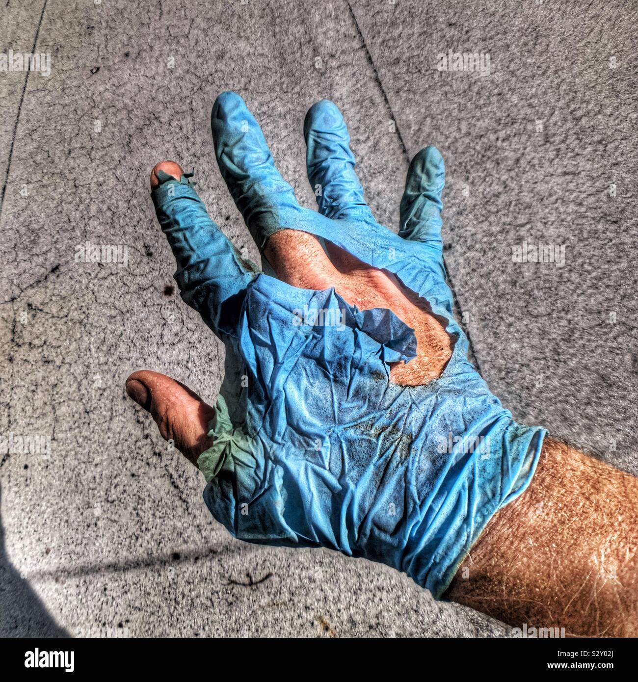 Working hard wore out rubber glove Stock Photo - Alamy