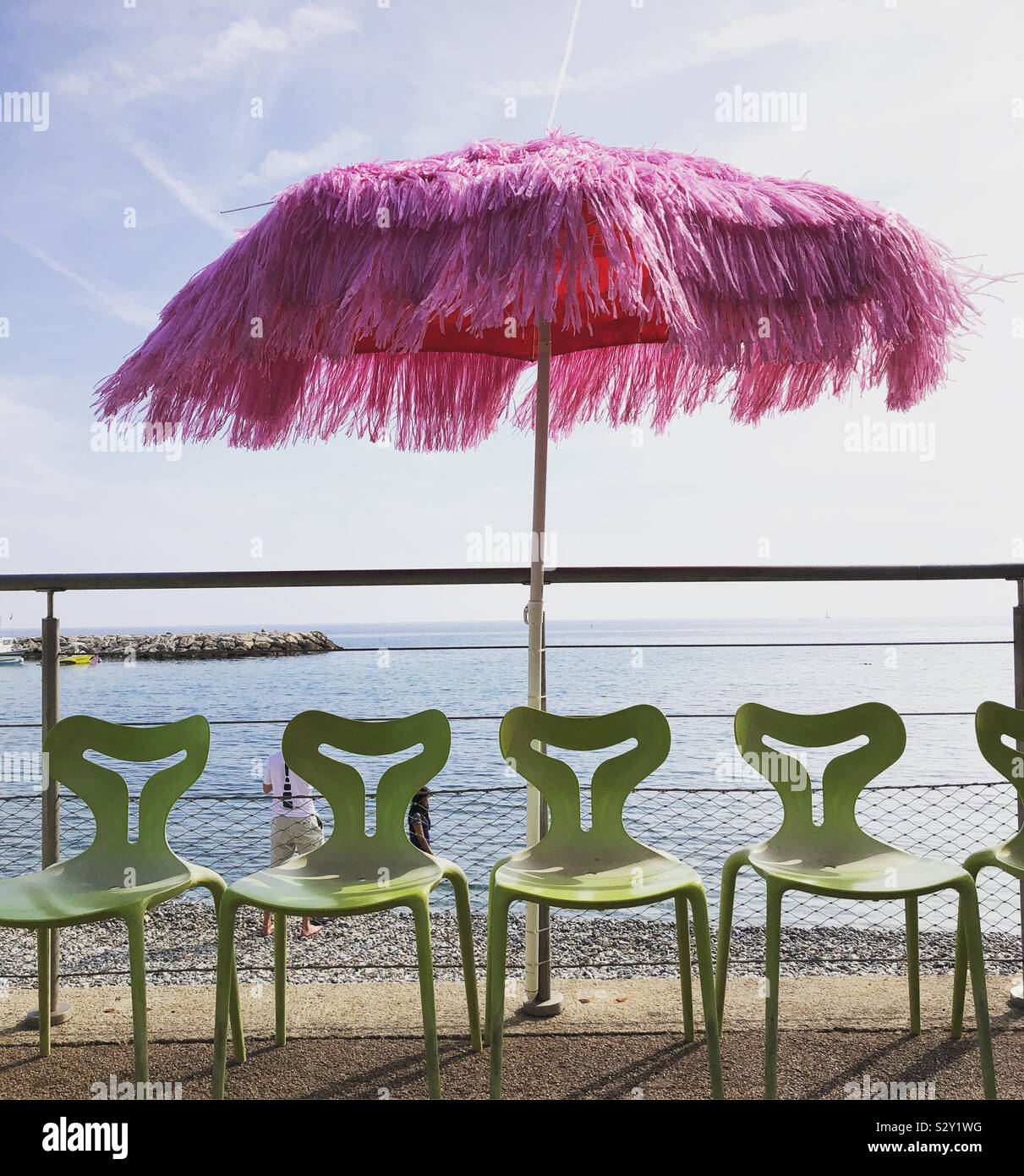 Chairs and umbrella along the waterfront, Menton, France, October 2019 ...