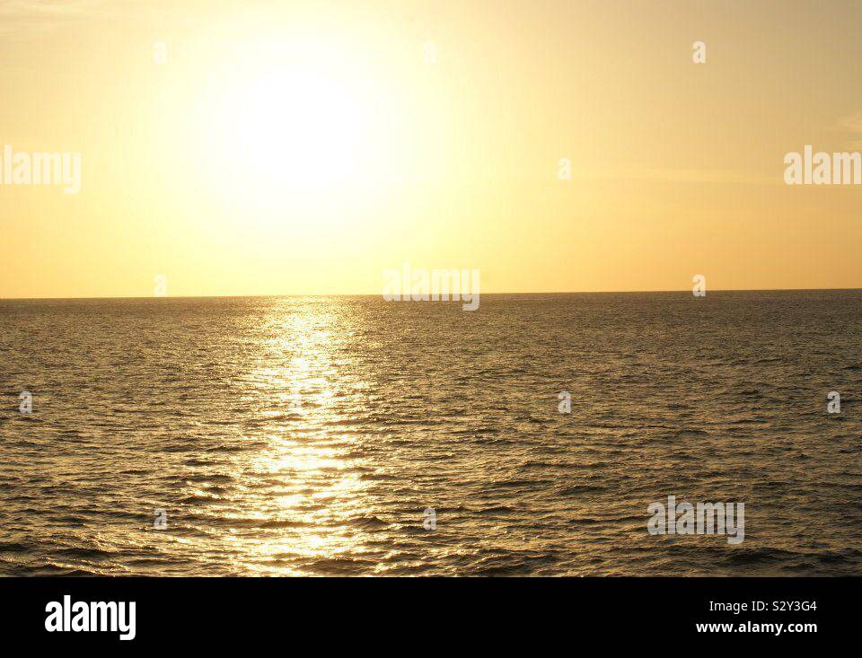When the sun meets the sea - sunsets Stock Photo - Alamy