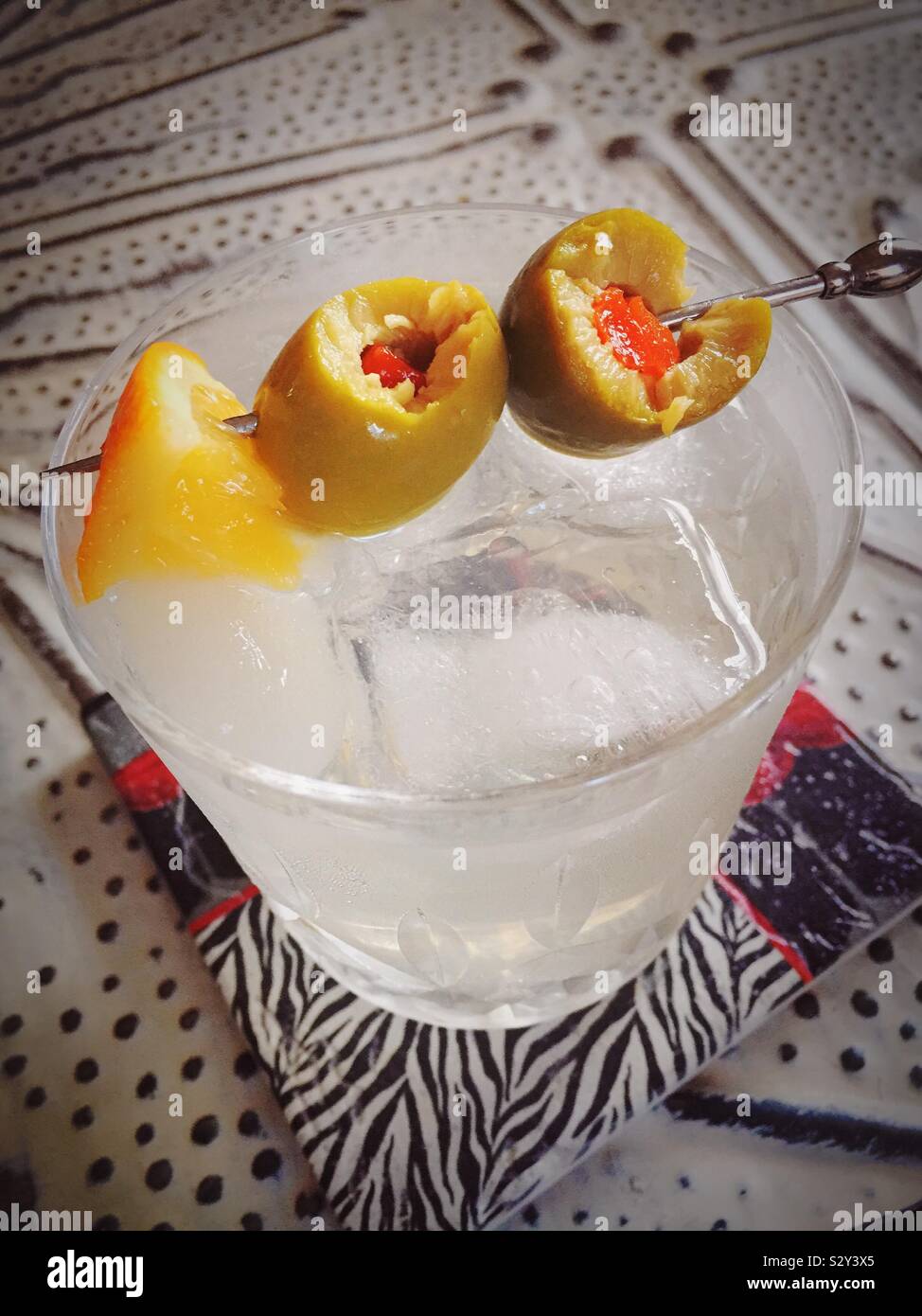 Martini on the rocks in a crystal glass with Half eaten olives and a ...