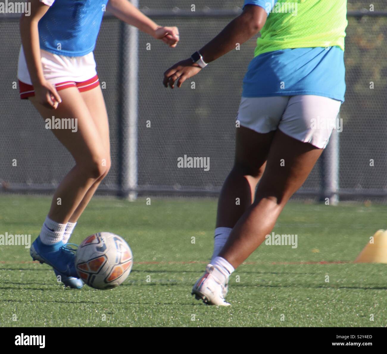 Getting ready to pass the soccer ball while the defender tries to make ...