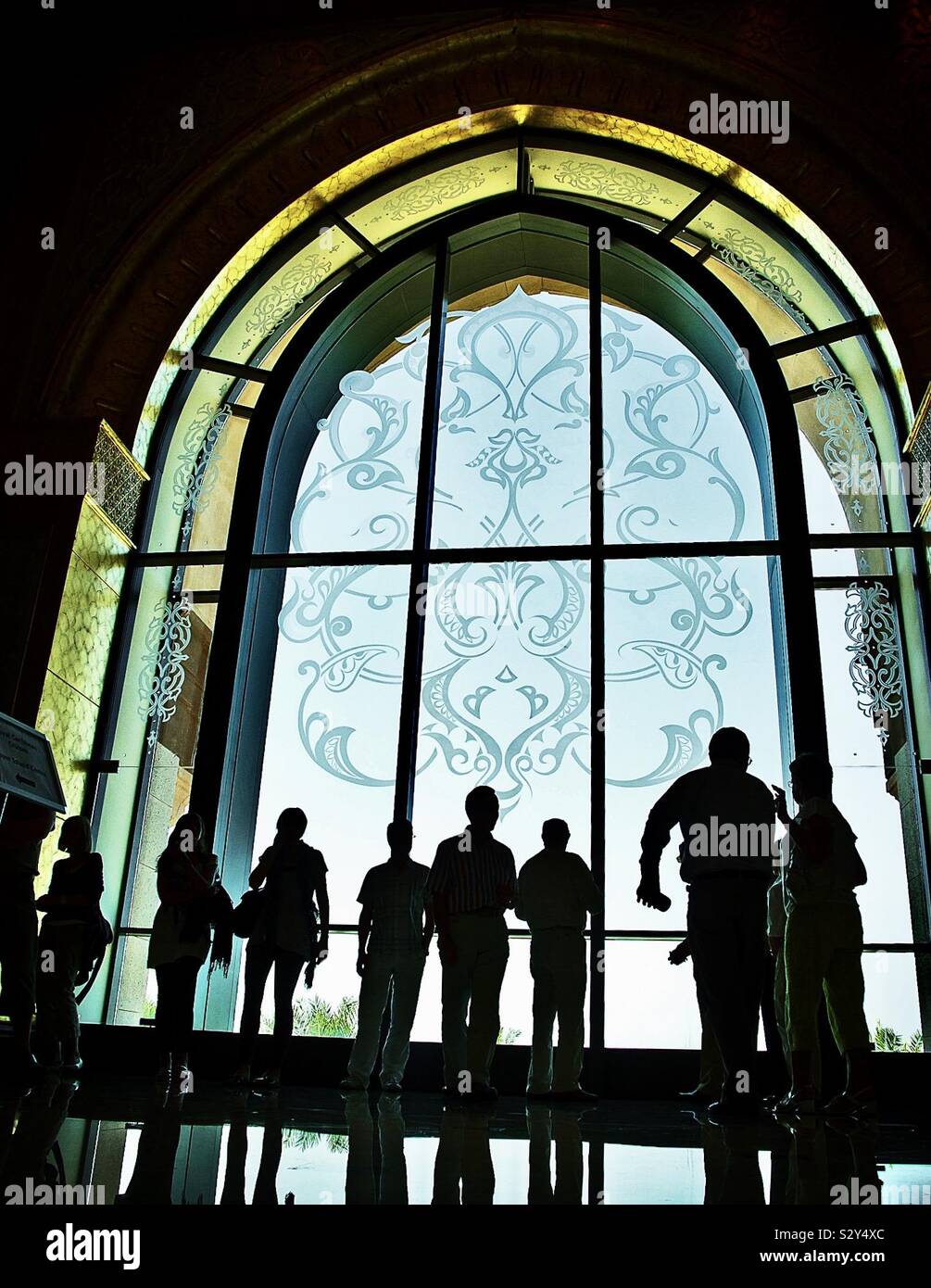 People looking out of ornate window Stock Photo - Alamy