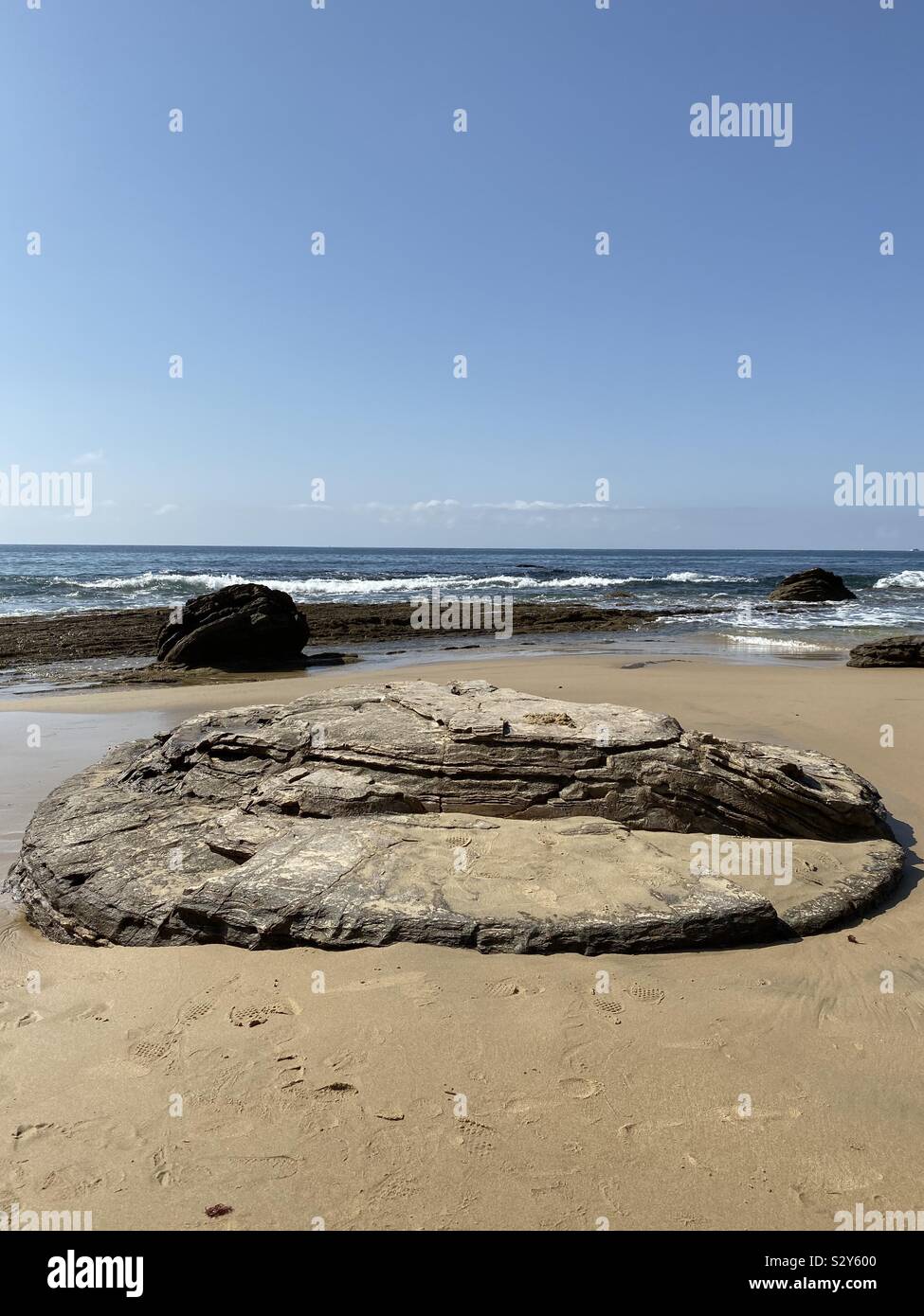 Large rock formations on the beach with view of Pacific Ocean in ...