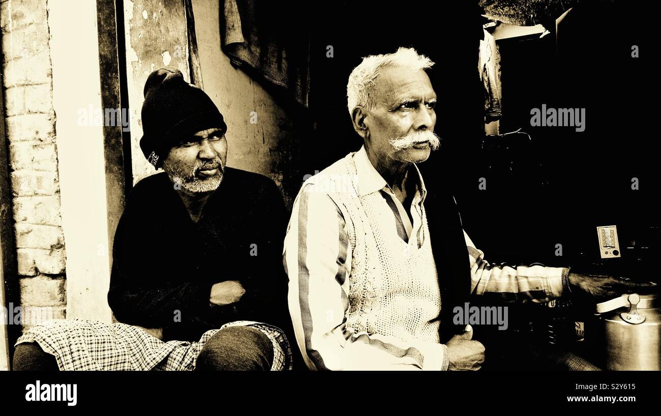 Two old Indian chaps in Varanasi celebrating a shanti moment, while one ...
