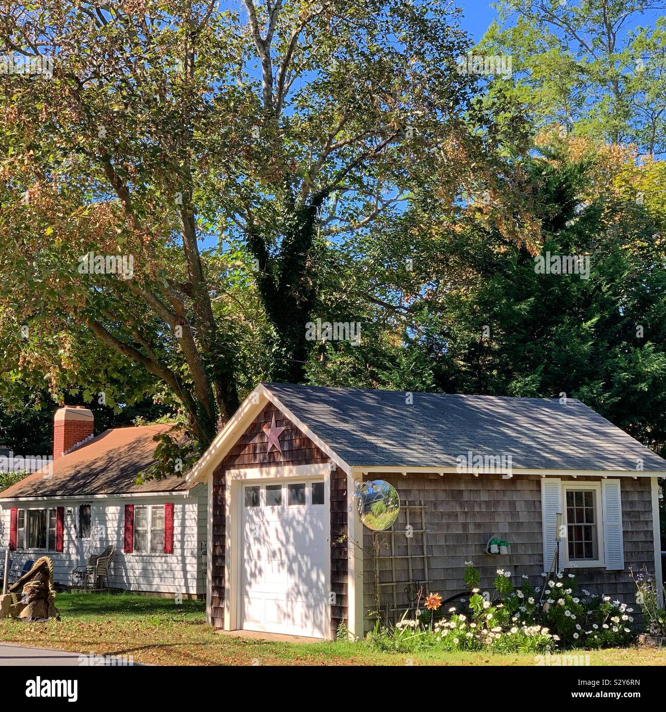 Autumn image of a garage and home under trees in Wellfleet, Cape Cod ...