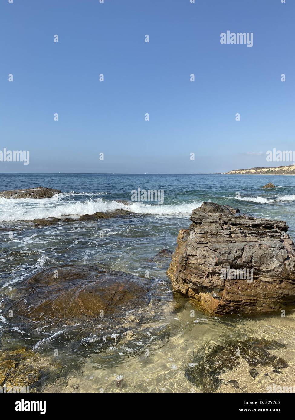 Seascape of California beach with large rock formations on the ...