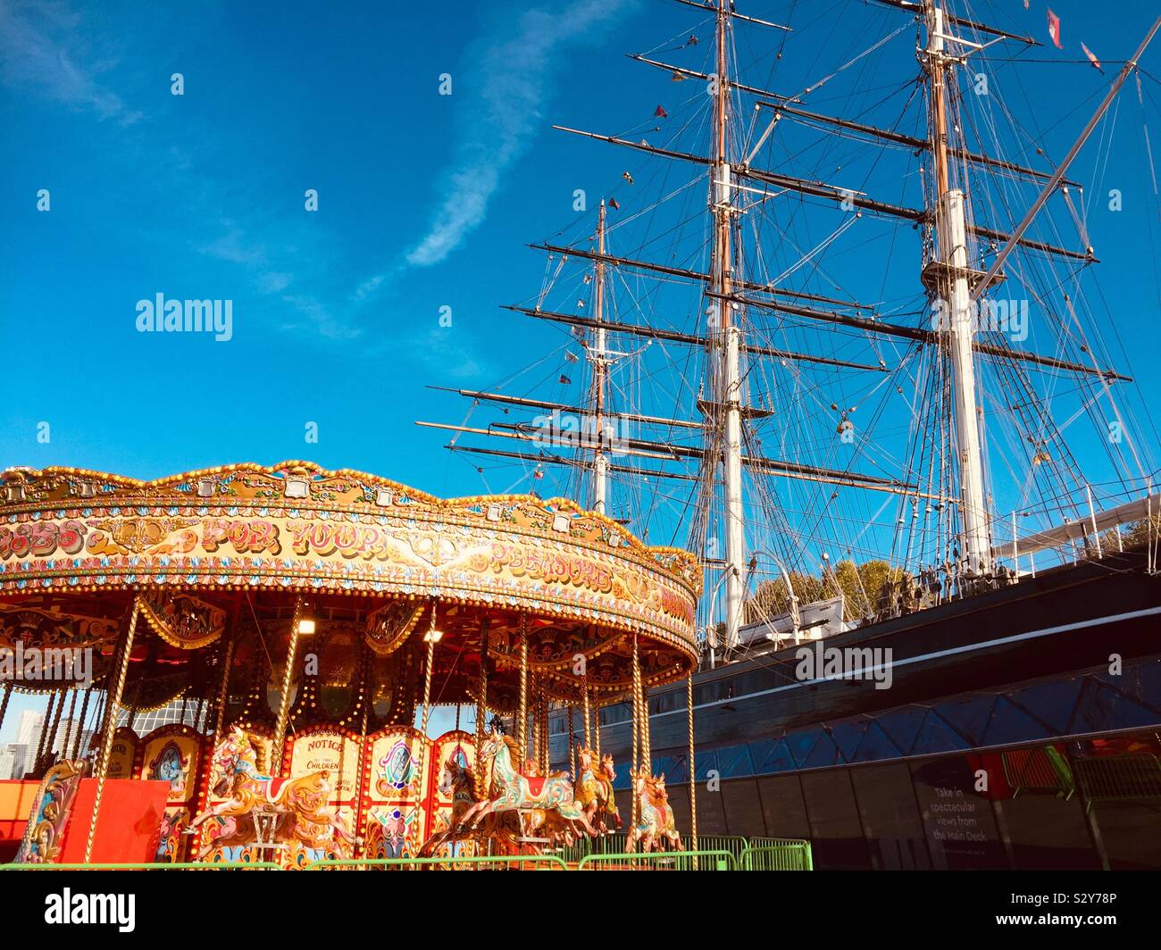 Greenwich autumn carousel and Cutty sark ship Stock Photo - Alamy