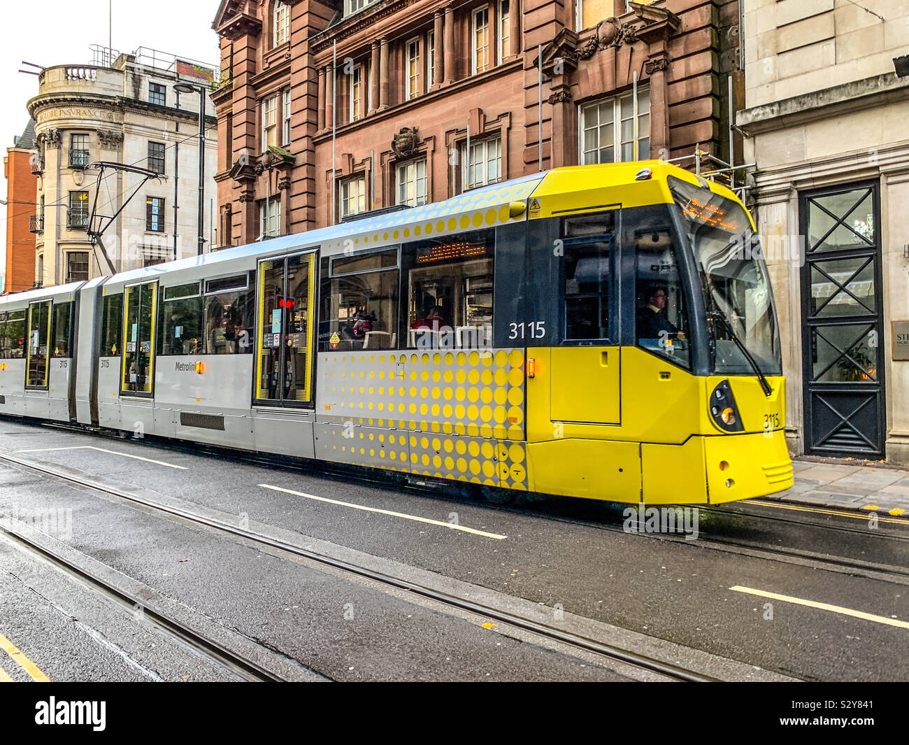 Metrolink tram on cross street in Manchester Stock Photo - Alamy
