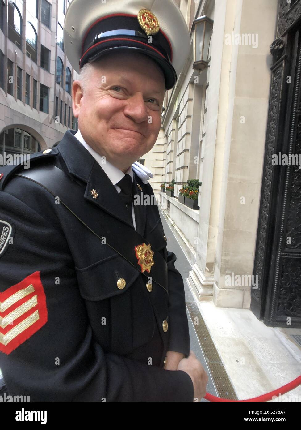 Smiling man guard welcoming visitors to Clothworkers Hall London Stock ...
