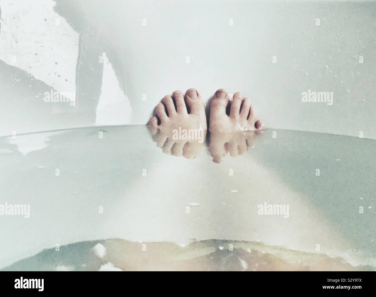 Women’s toes peeking above bath water with reflection Stock Photo - Alamy