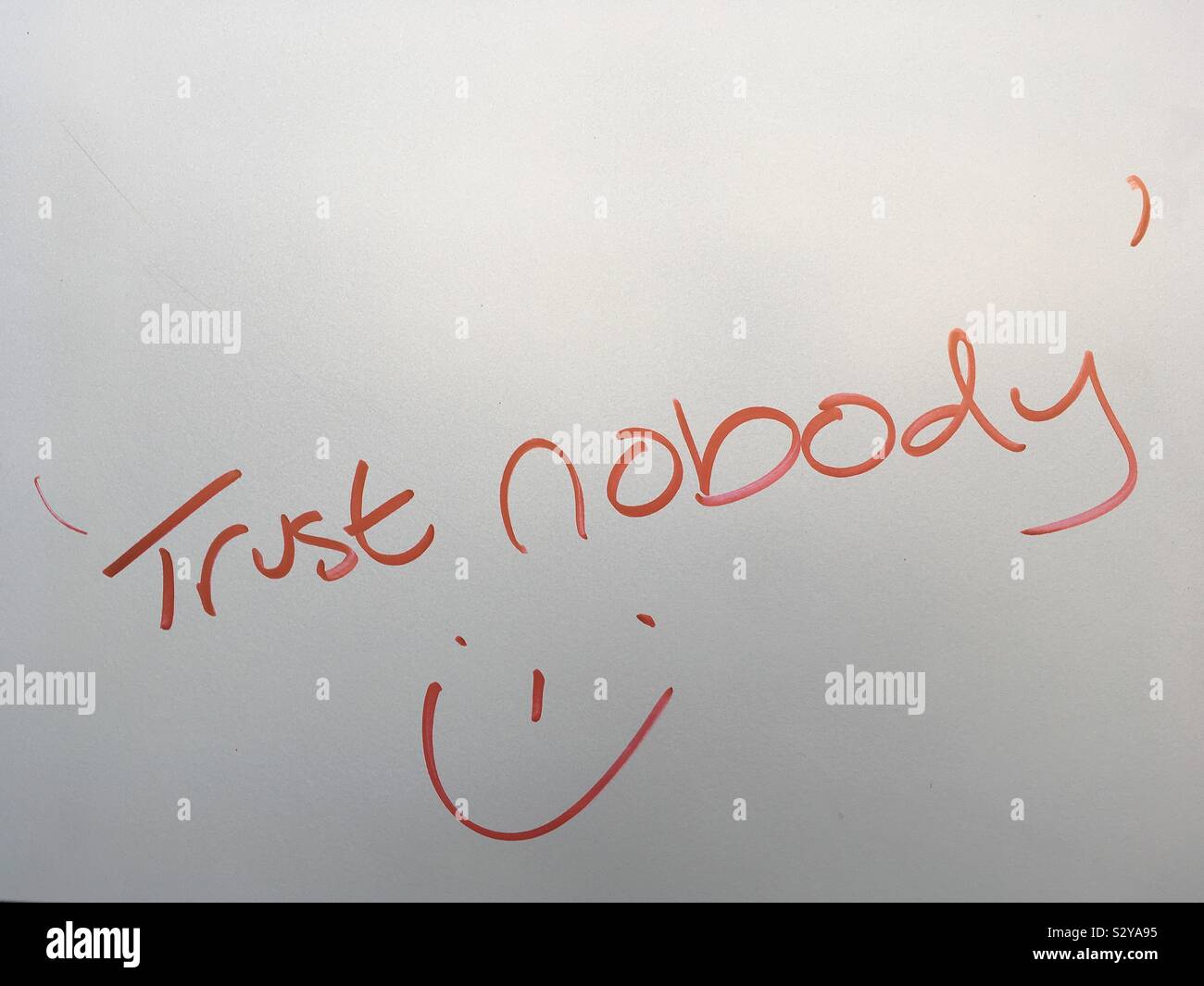Graffiti reading “Trust nobody” accompanied by a smiley face Stock ...