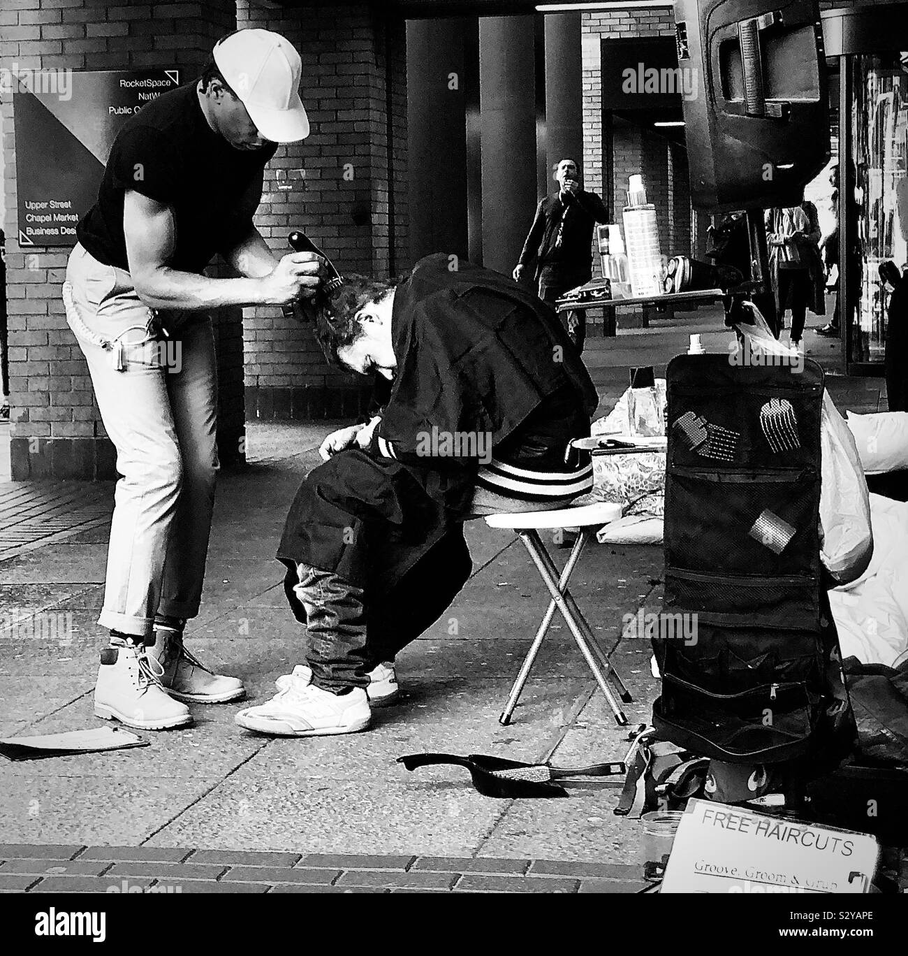 Street barber in London offering free haircuts Stock Photo - Alamy