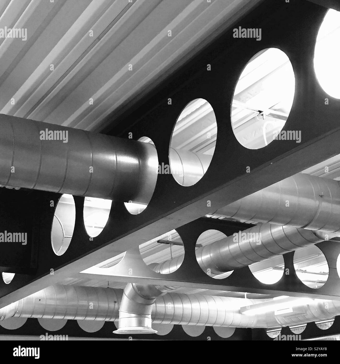 Modernist architectural interior ventilation ducting. Steel girders ...