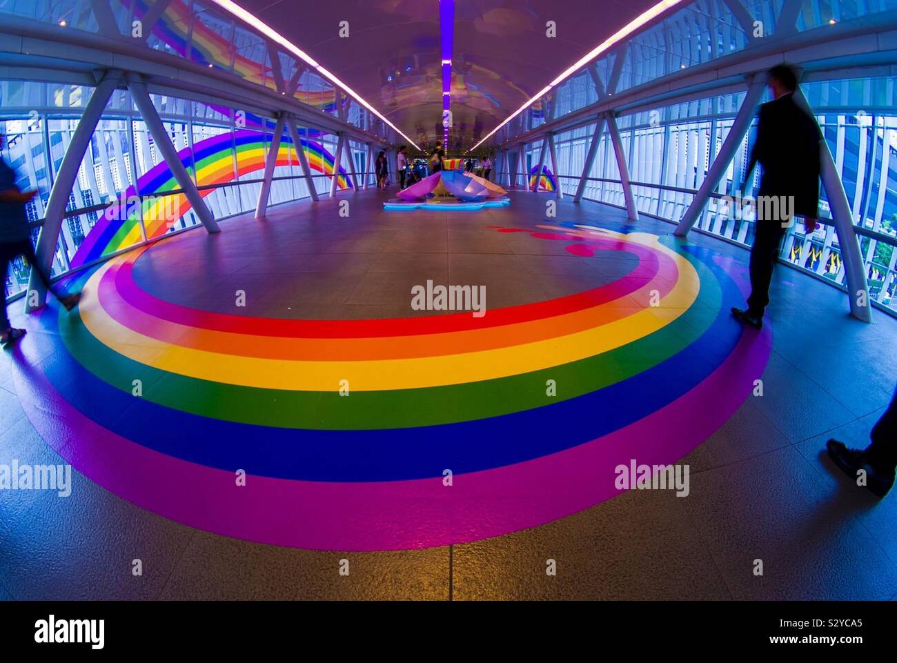 Rainbow painted on walkway floor and windows Stock Photo - Alamy