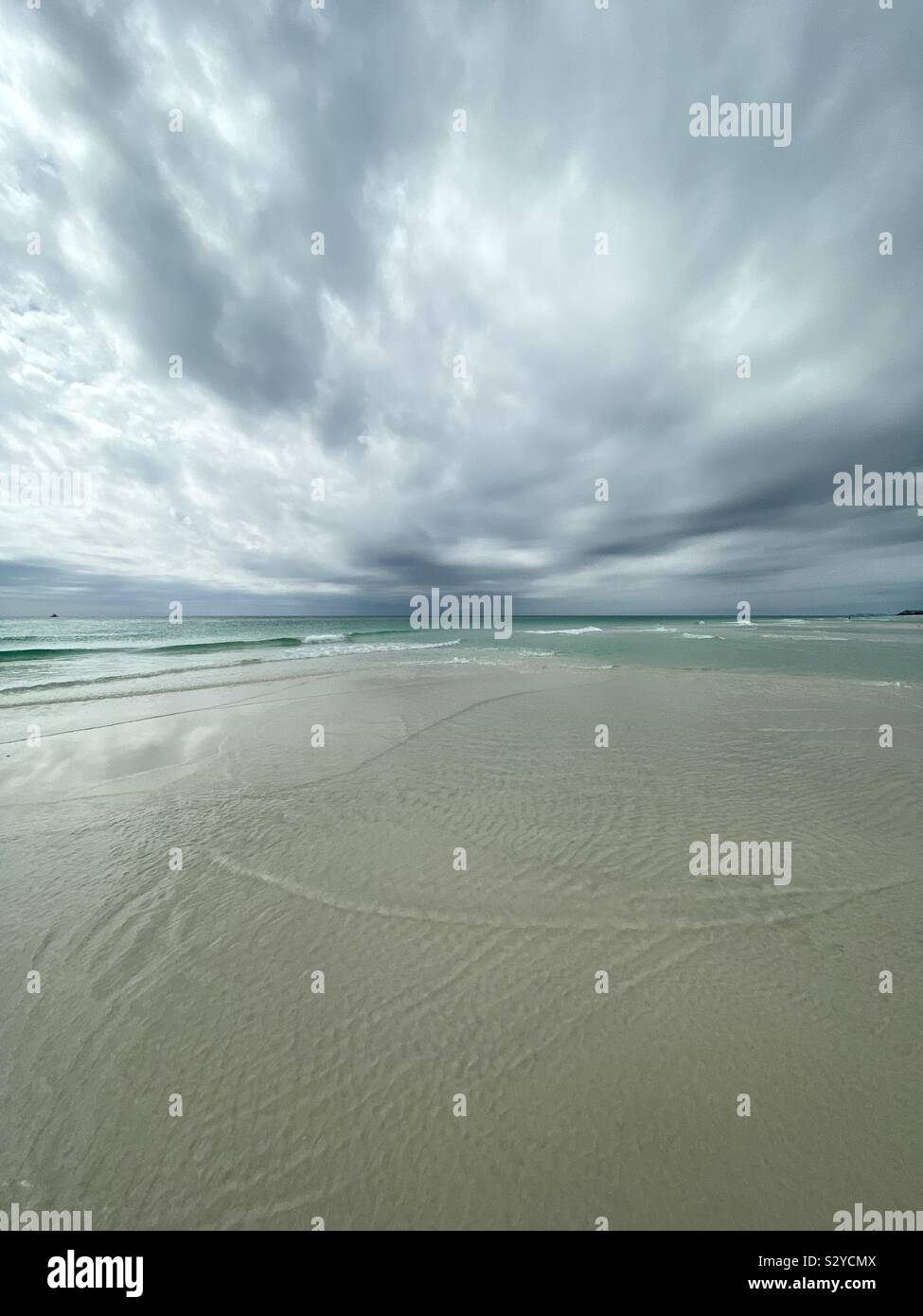 Large storm cloud formations over turquoise ocean water Stock Photo - Alamy