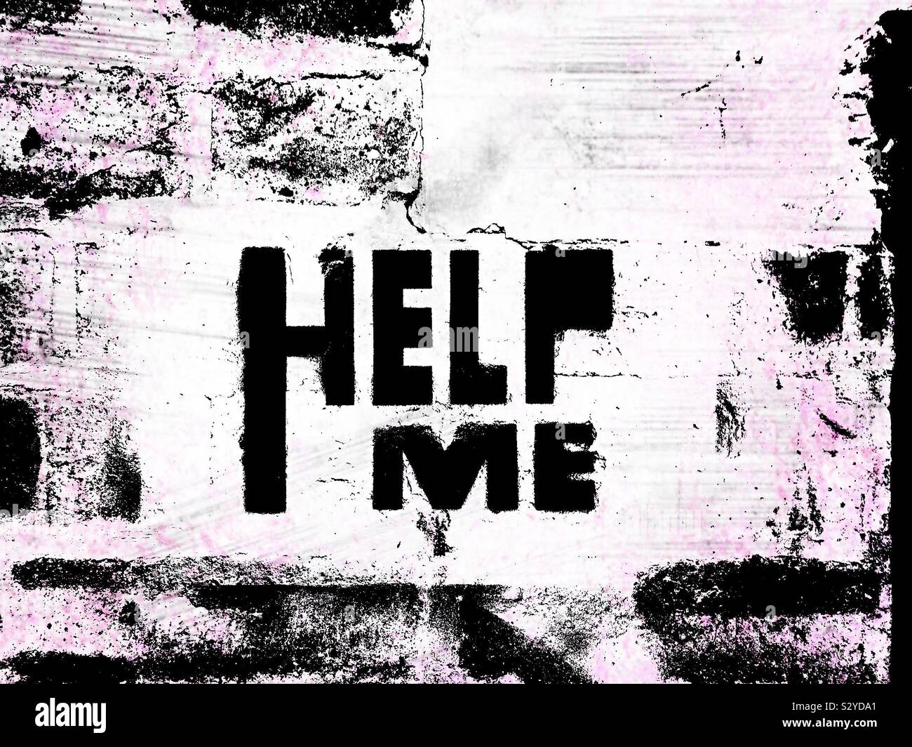 Help me stencilled graffiti on brick wall Stock Photo - Alamy